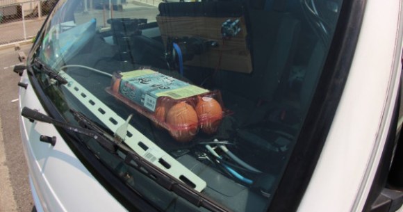 Easy lunch – Man cooks a batch of eggs on his car dashboard in the ...