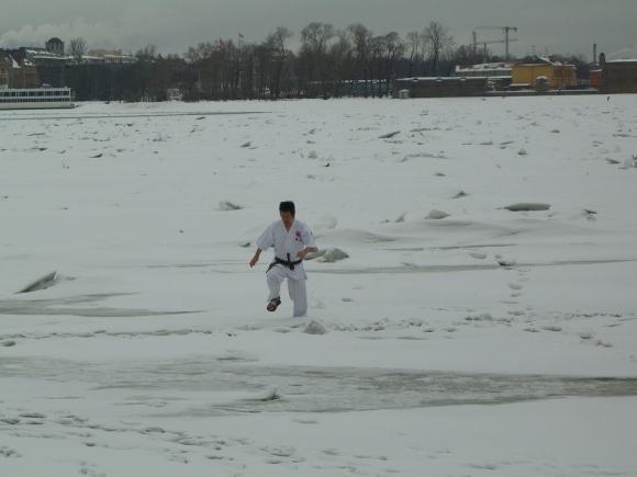 Karate dojo students practice under freezing waterfall… in the middle ...