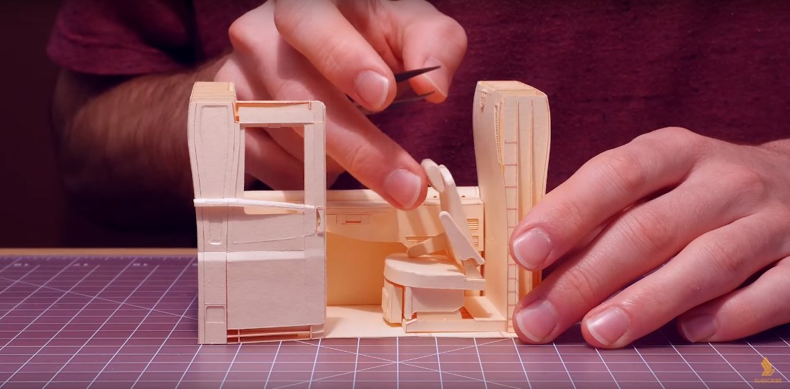 Artist takes paper planes to the next level, builds tiny seats complete ...