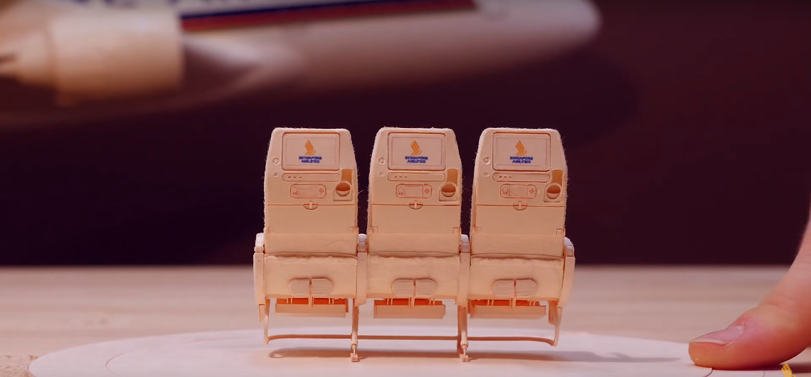 Artist takes paper planes to the next level, builds tiny seats complete ...