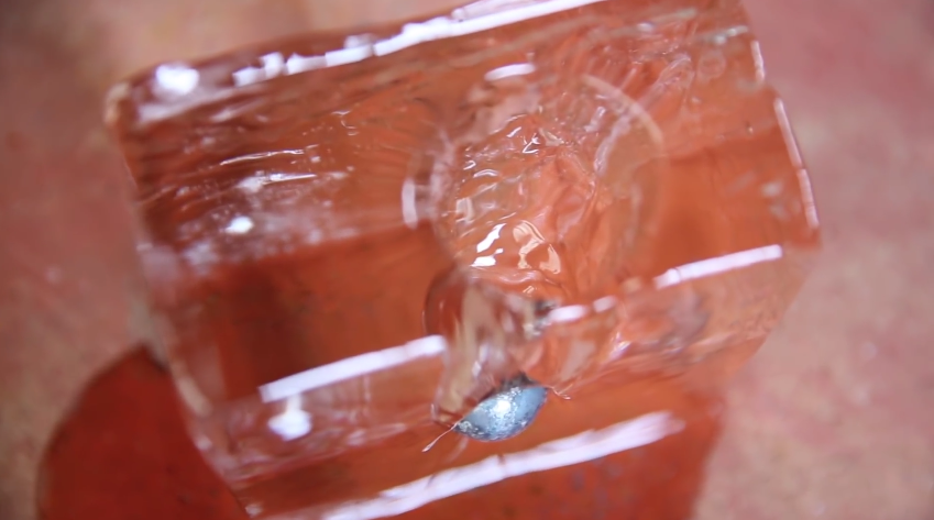 Watch a super hot ball of iron get dropped onto an ice cube, because ...