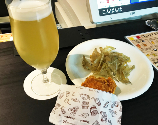 We order a craft beer at the combi conbini standing bar near Hakata ...