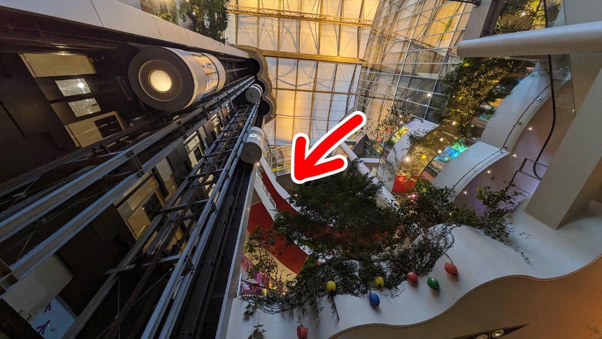 Unusual curved escalators are the crowning jewel of this shopping mall ...