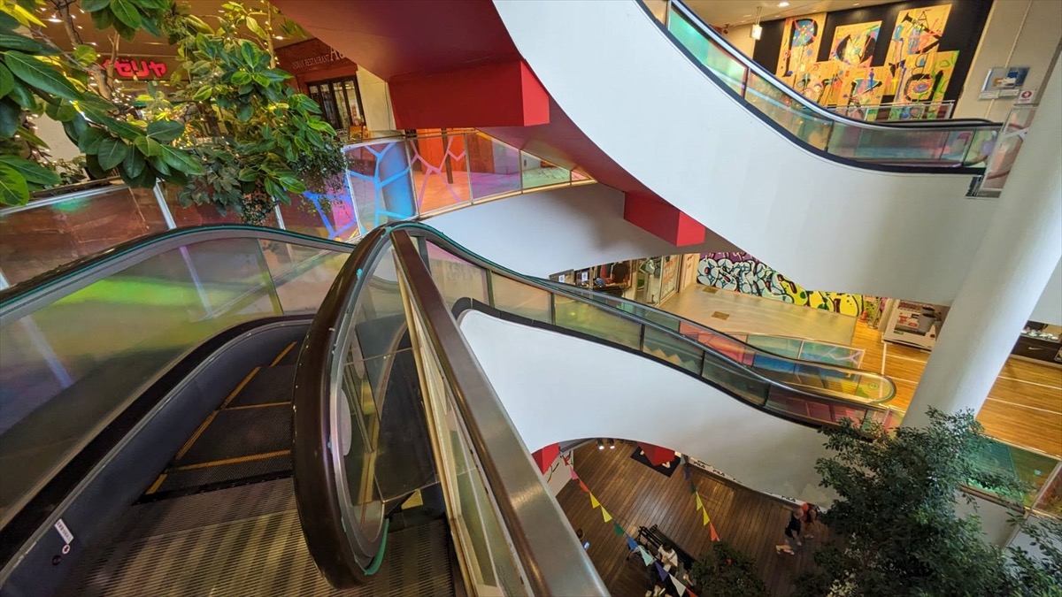 Unusual curved escalators are the crowning jewel of this shopping mall ...