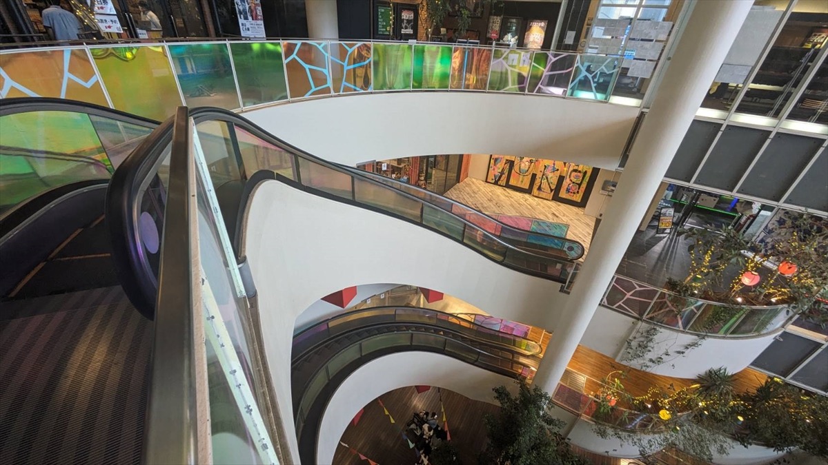 Unusual curved escalators are the crowning jewel of this shopping mall ...