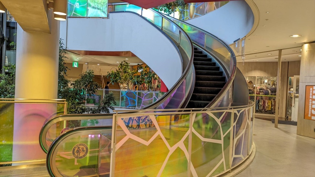 Unusual curved escalators are the crowning jewel of this shopping mall ...